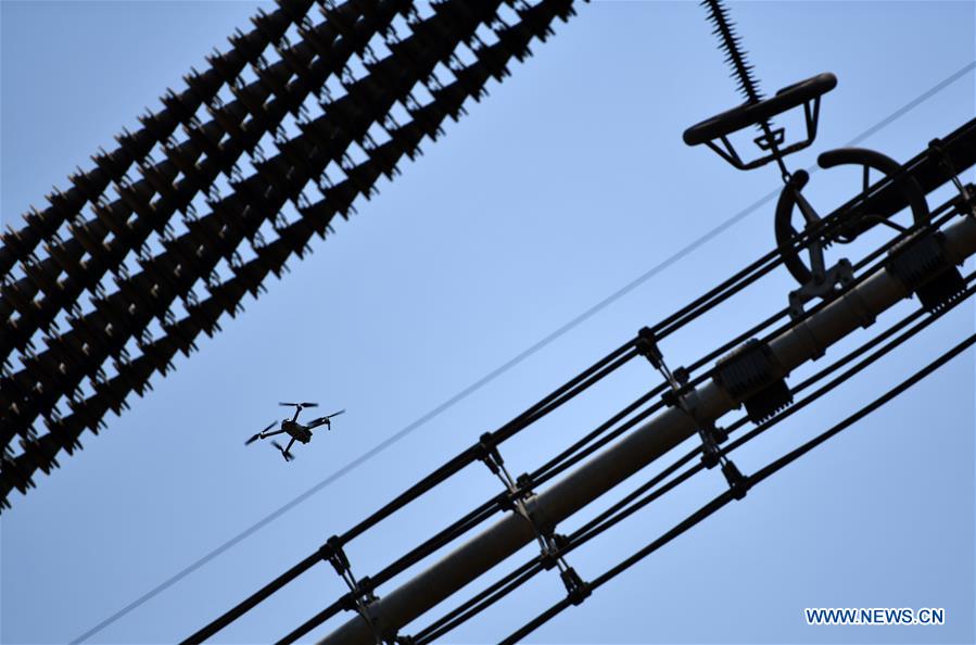 Engineers use drone to inspect high voltage power lines in Tianjin ...